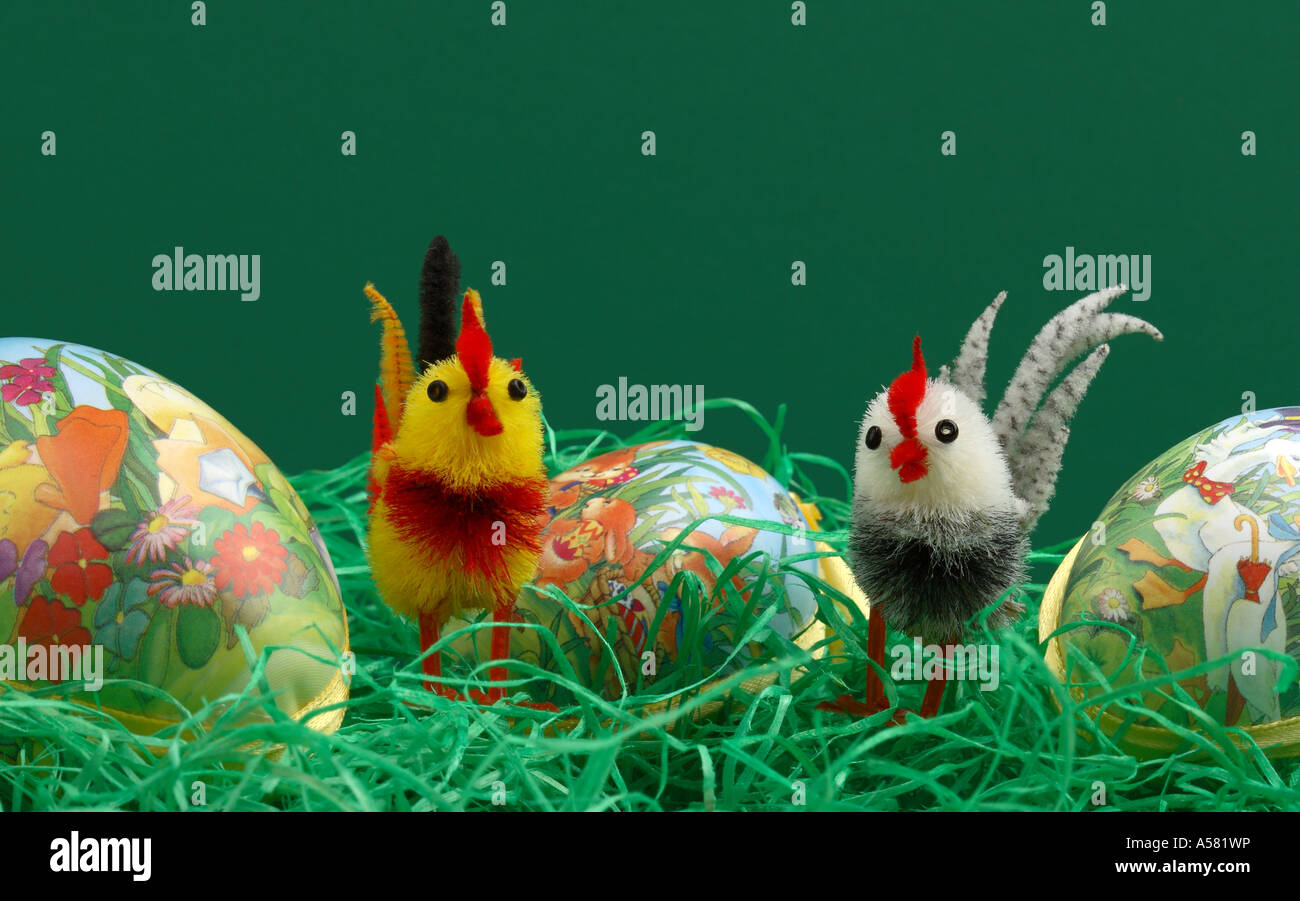 Colourful Easter figures and eggs in Easter grass Stock Photo - Alamy