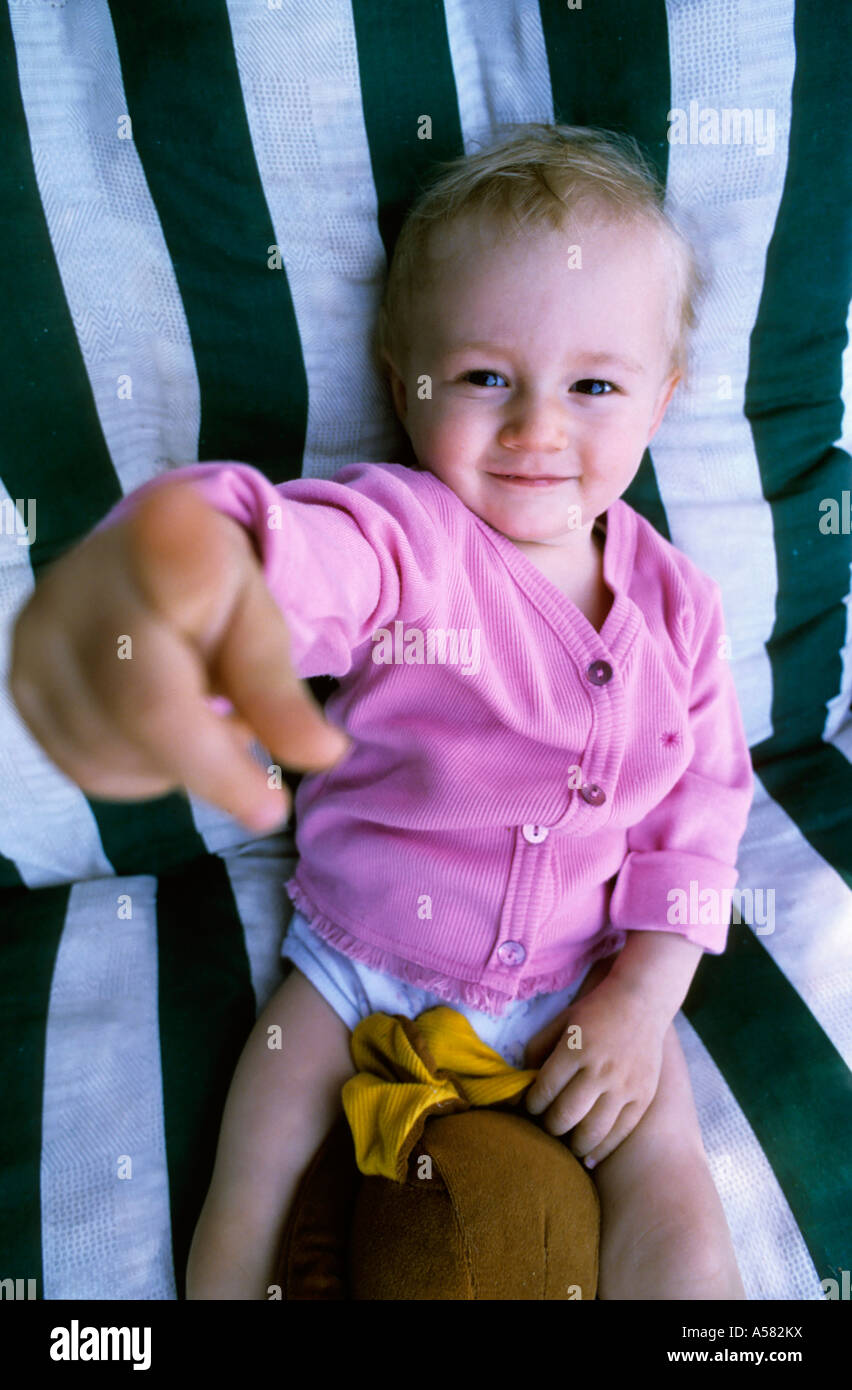 One year old baby girl pointing and smiling Stock Photo - Alamy