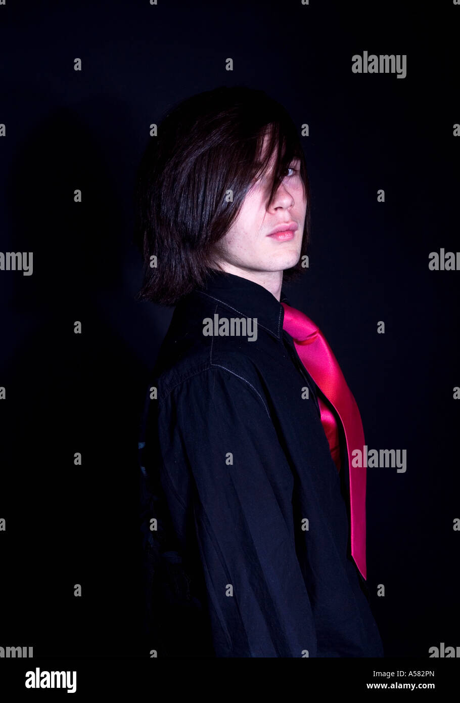 Young man aged sixteen cool sideways glance to camera wearing ...