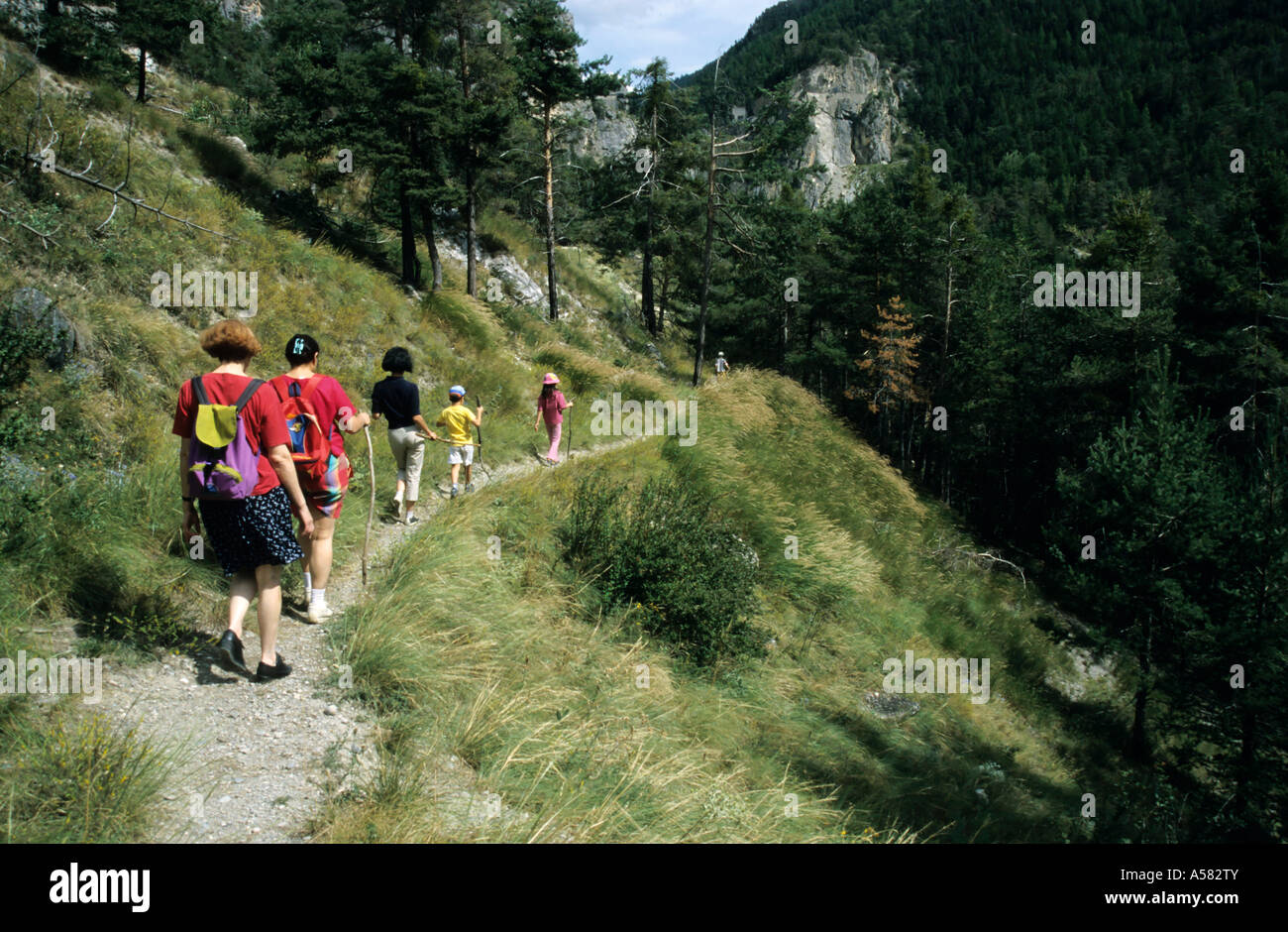 Family hiking down a mountain Stock Photo - Alamy