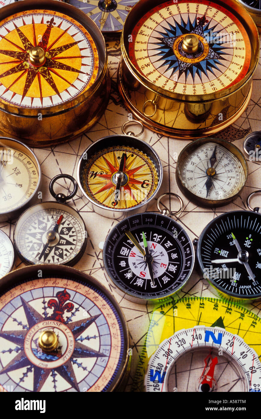 A bunch of different compasses on old map Stock Photo - Alamy