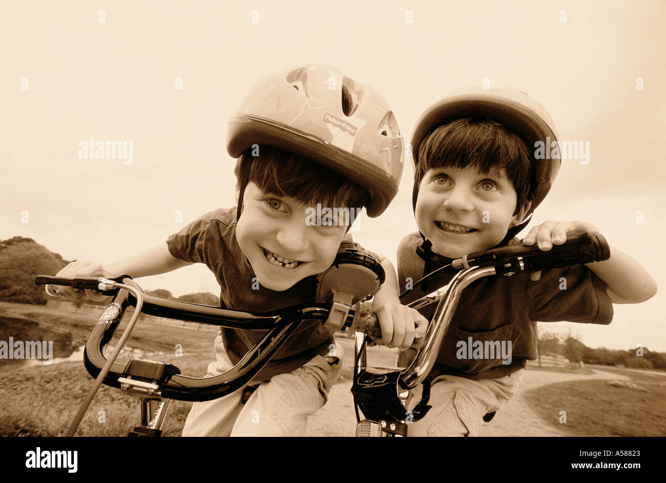 Two brothers riding bicycles hi-res stock photography and images - Alamy