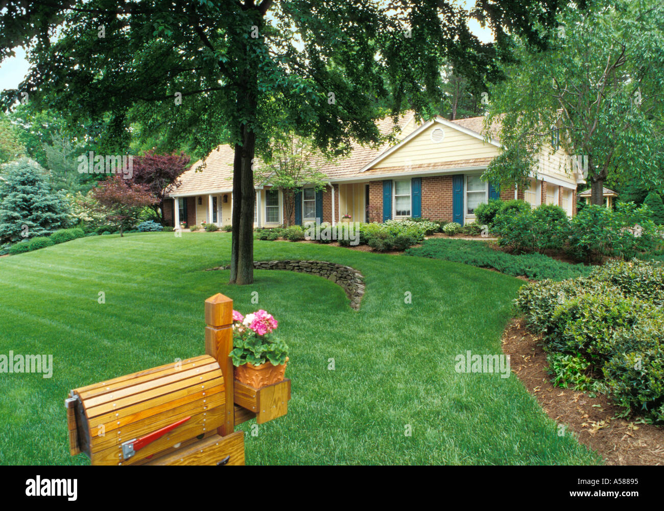 Wooden mailbox in front of single story red brick house Property ...