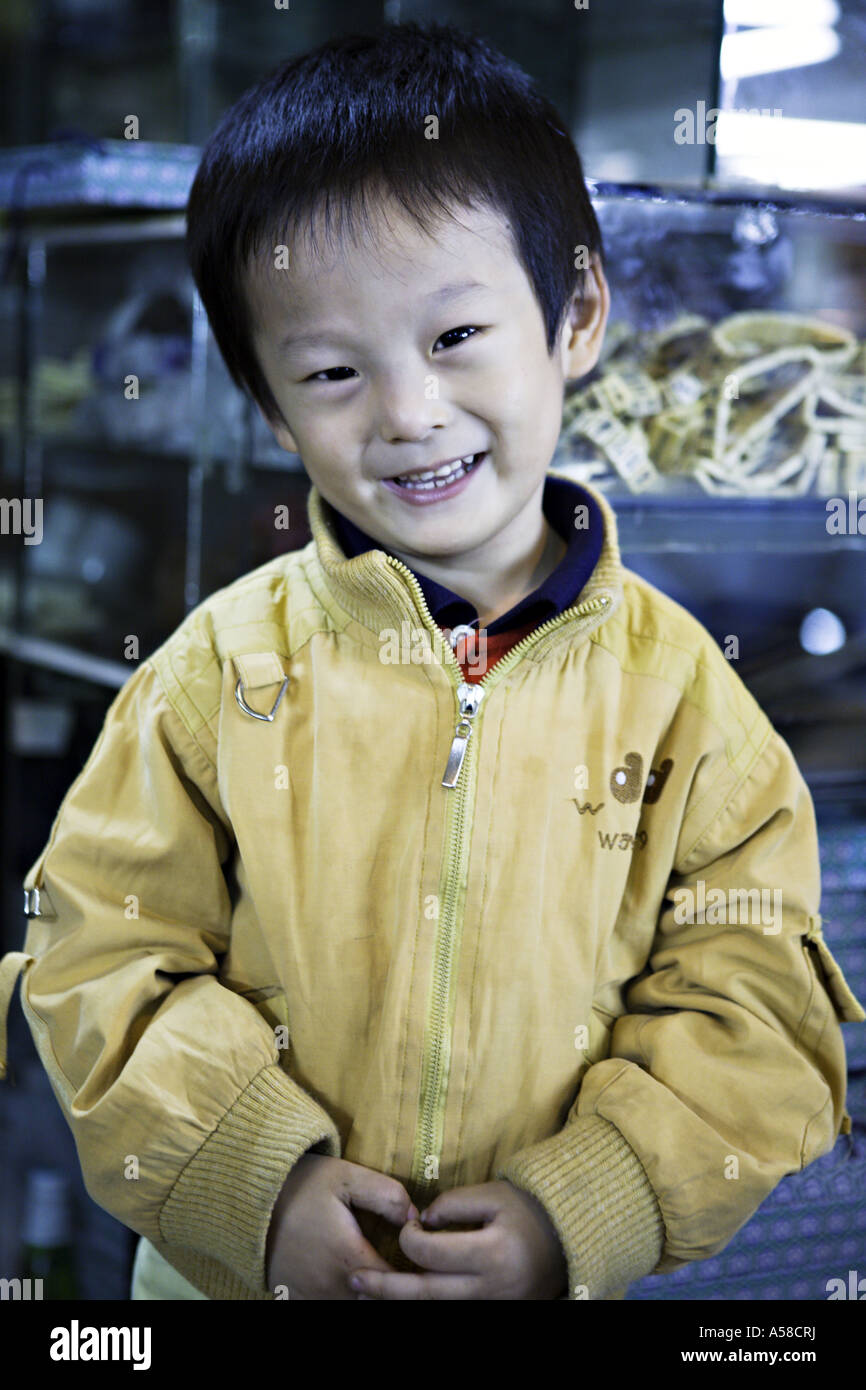 CHINA SHANGHAI Cute young Chinese school age boy smiles for the camera ...
