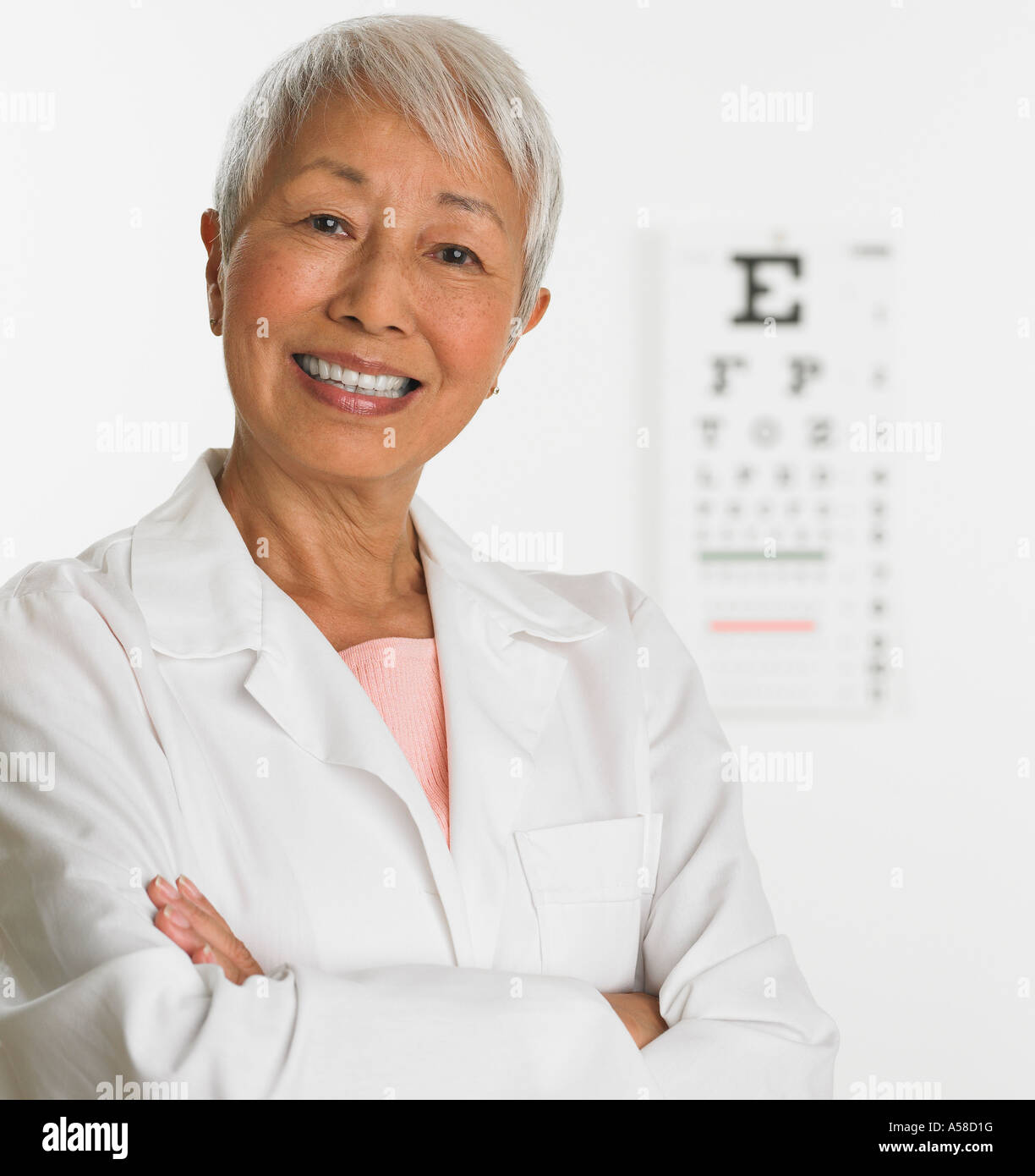 Senior Asian female doctor with eye chart in background Stock Photo - Alamy