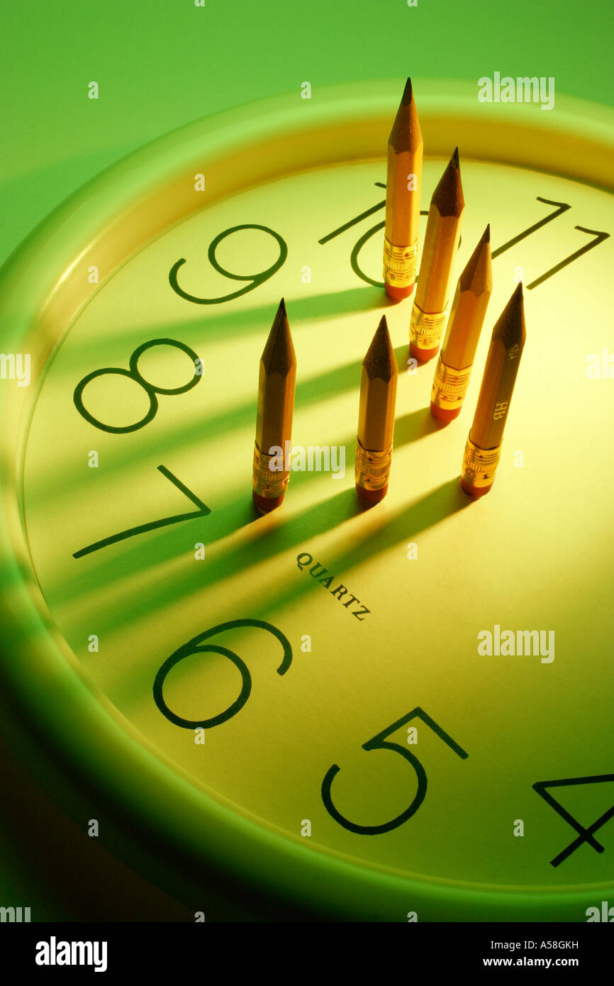Pencils on Clock Stock Photo - Alamy