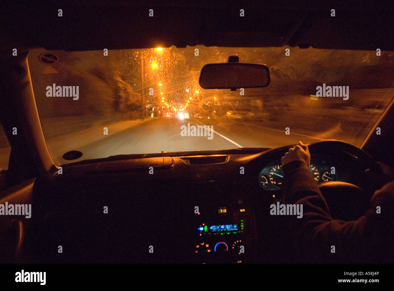 view from a car traveling at night showing the back of a lorry Stock ...