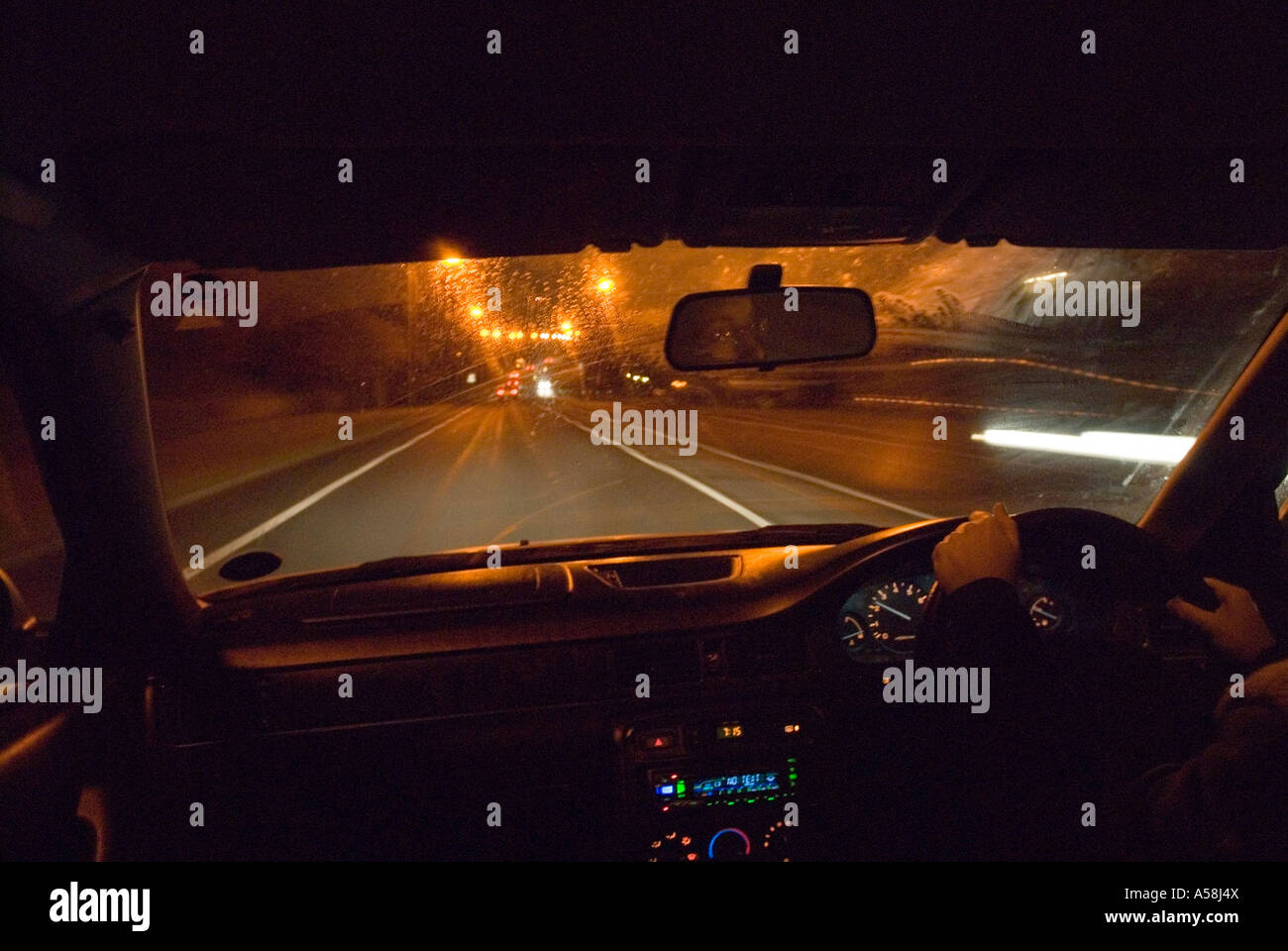 view from a car traveling at night showing the back of a lorry Stock ...