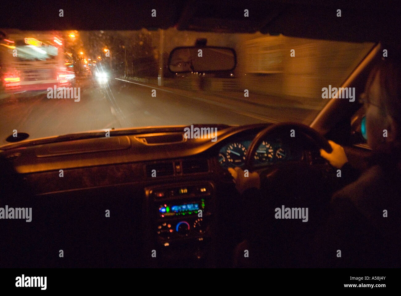 view from a car traveling at night showing the back of a lorry Stock ...