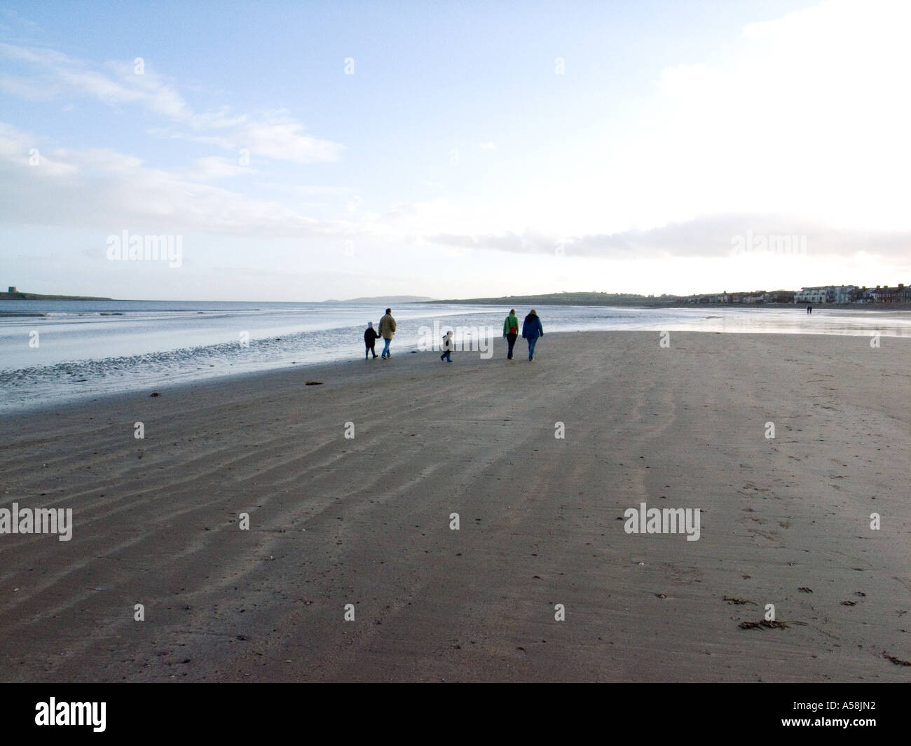 A family out for a walk on the sands of Skerries beach, north county ...
