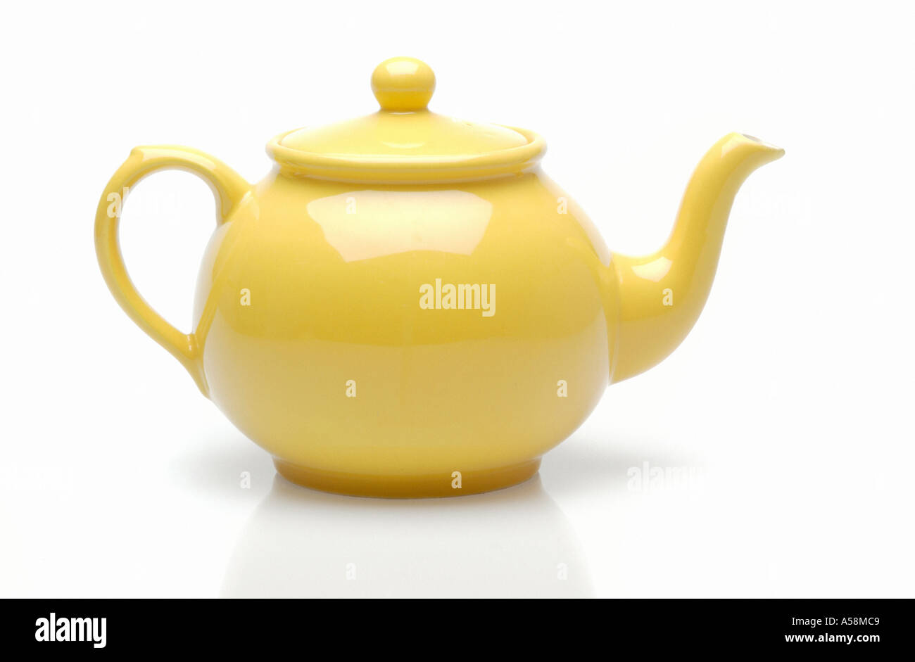 Simple yellow teapot on white background Stock Photo - Alamy