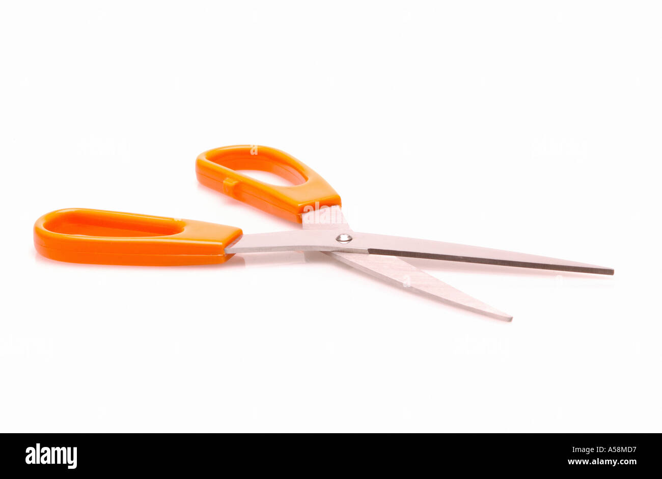Orange handles scissors laying on white background with blades open ...