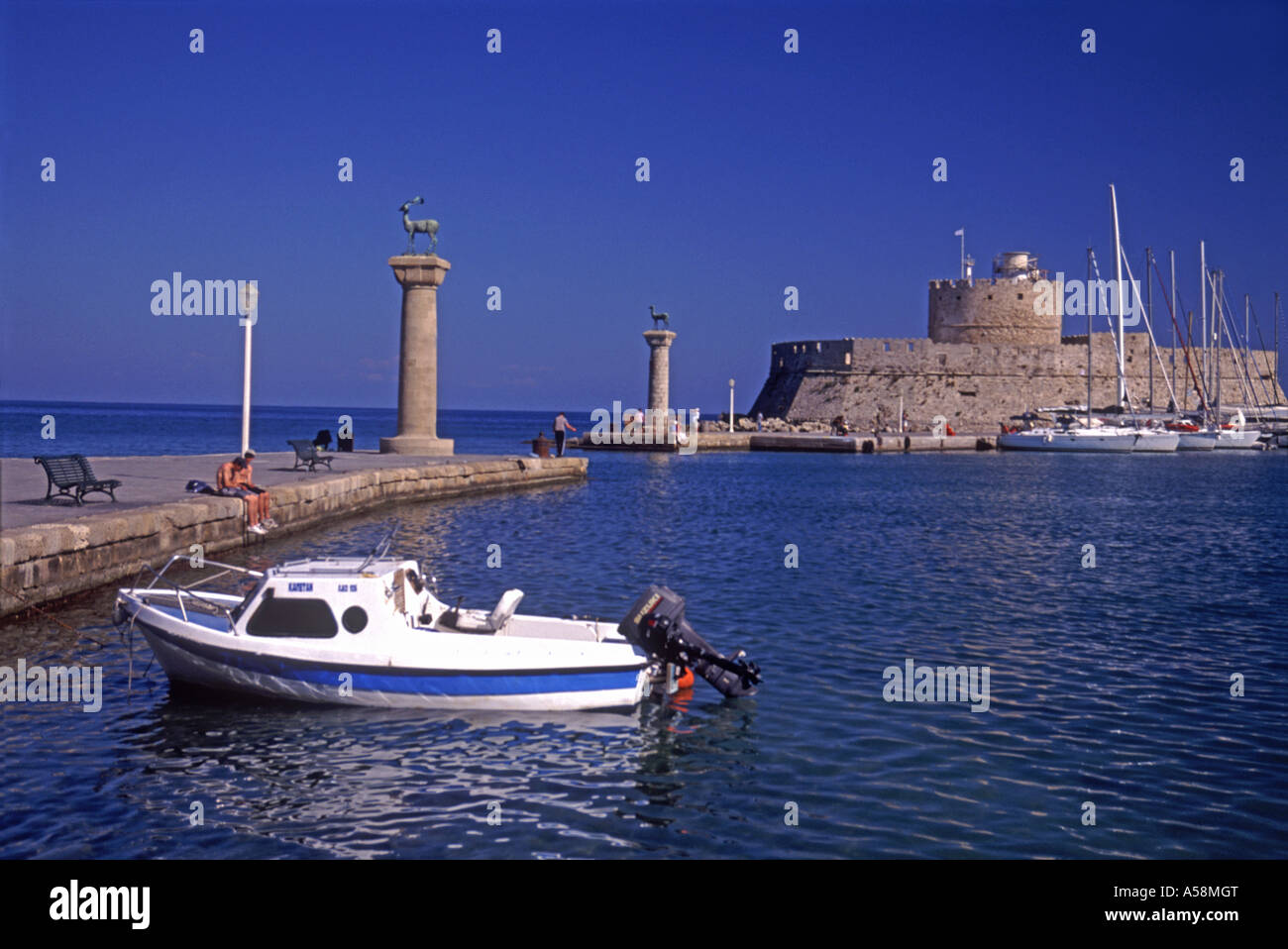 Mandraki harbor Rhodes, Greece where once the Colossus of Rhodes statue ...