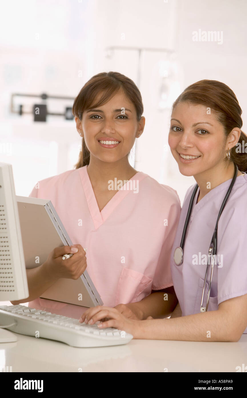 Portrait of two nurses in front of computer Stock Photo - Alamy