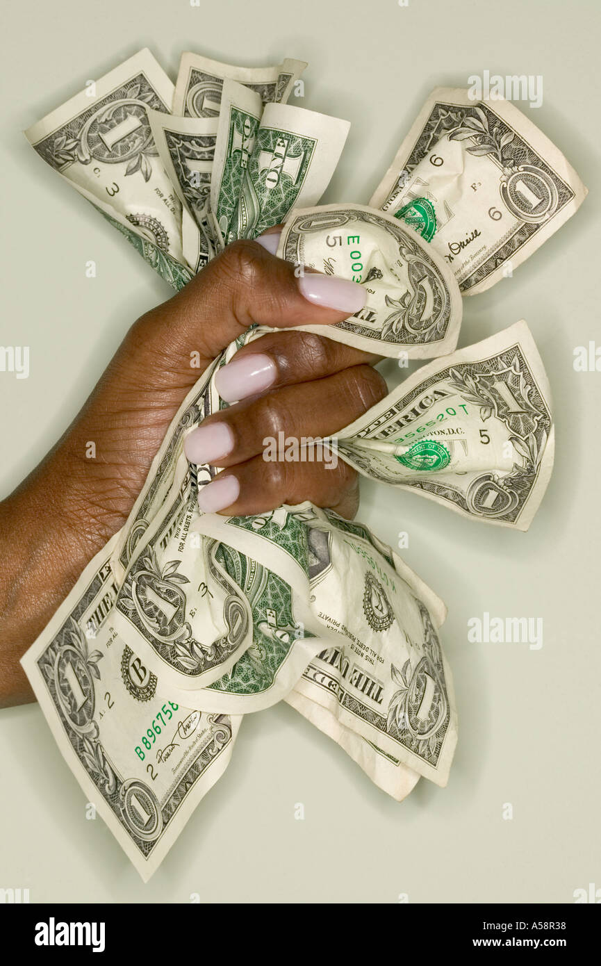 Close up of hands squeezing dollar bills Stock Photo - Alamy