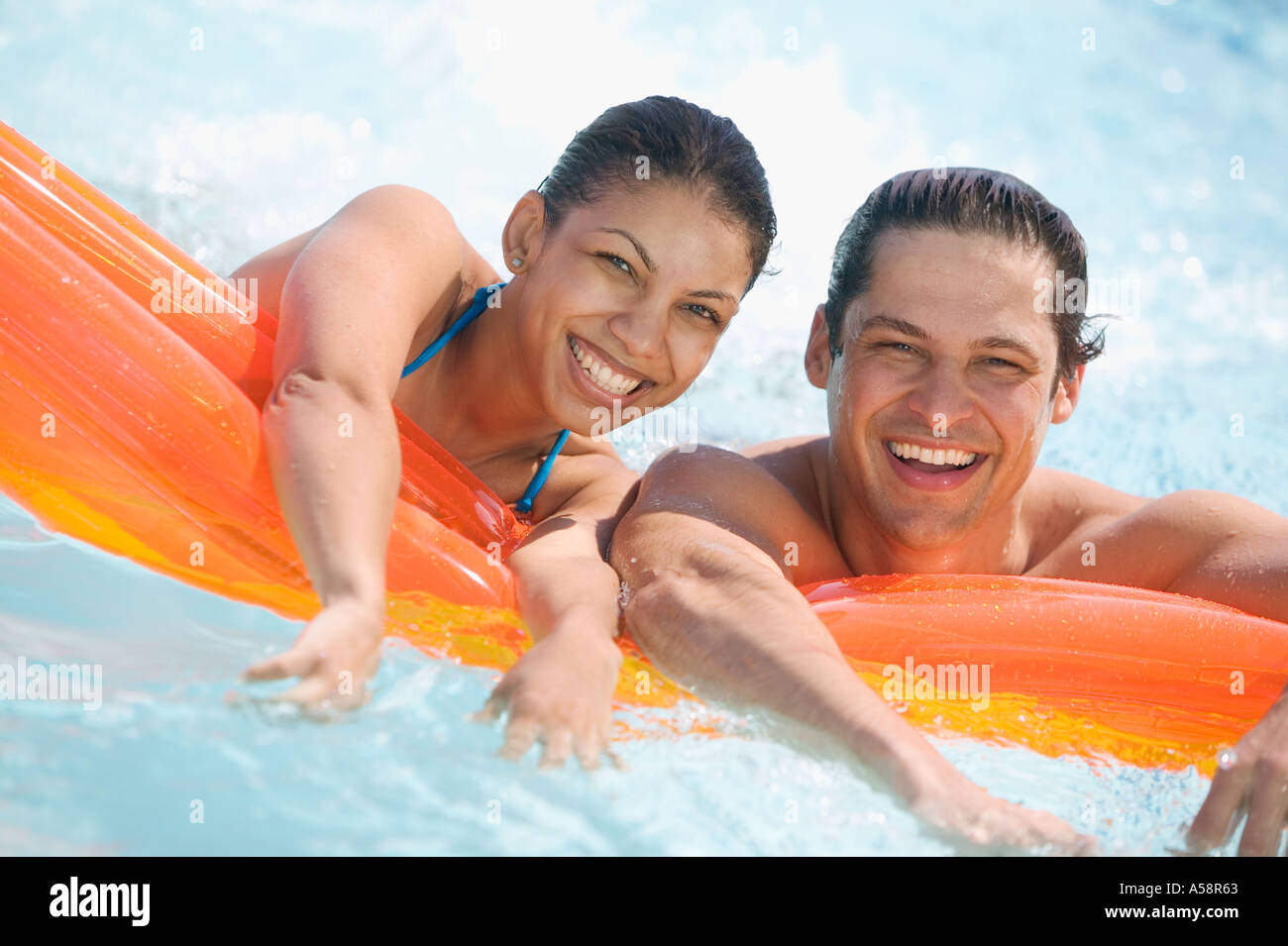 Portrait of couple in swimming pool Stock Photo - Alamy