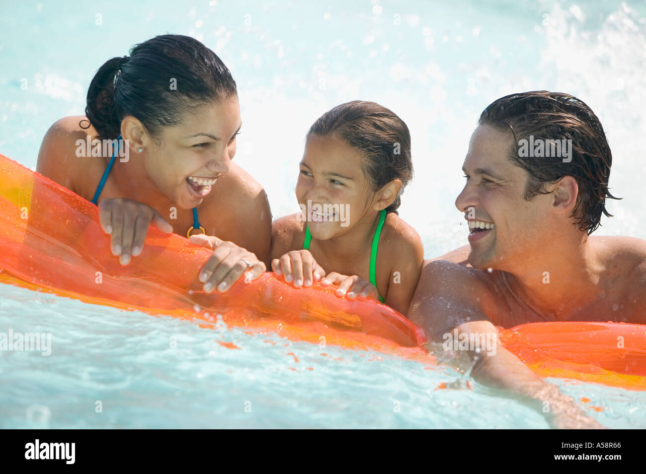 Family in swimming pool Stock Photo - Alamy
