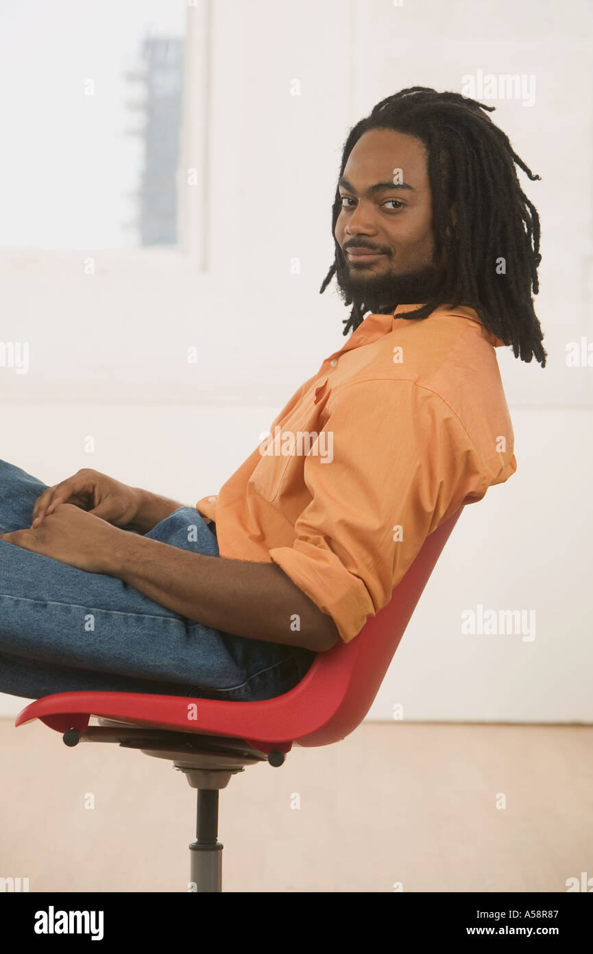 Portrait of man sitting in chair Stock Photo - Alamy