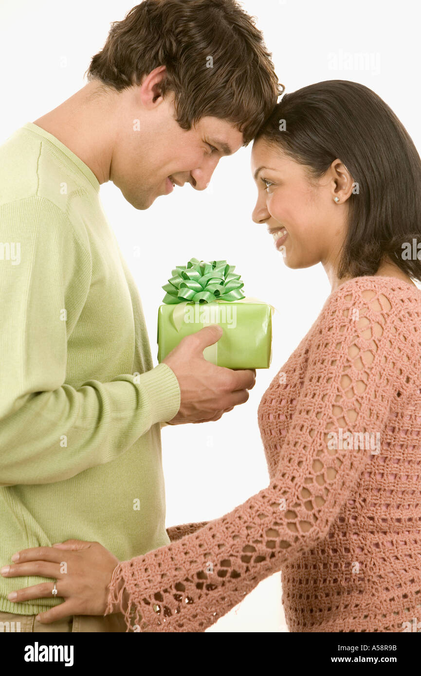Profile of man giving gift to woman Stock Photo - Alamy