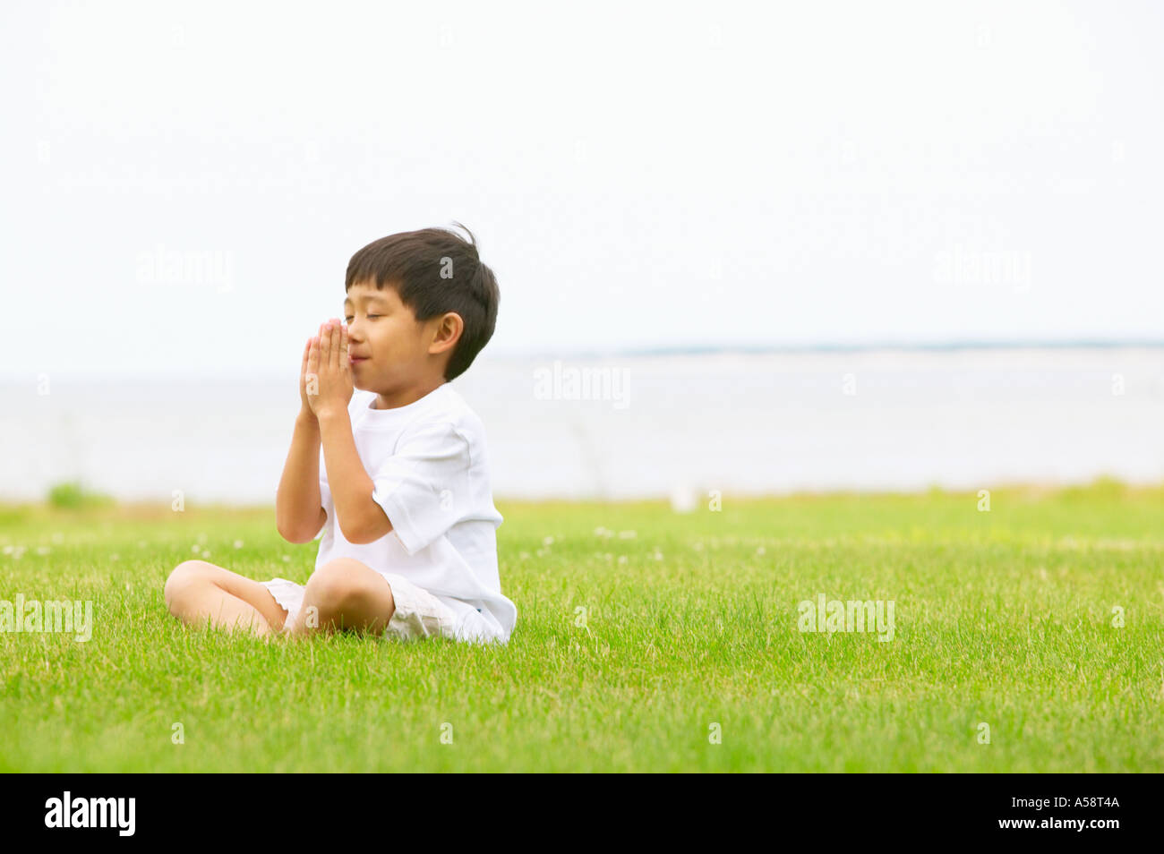 Young boy praying Stock Photo - Alamy