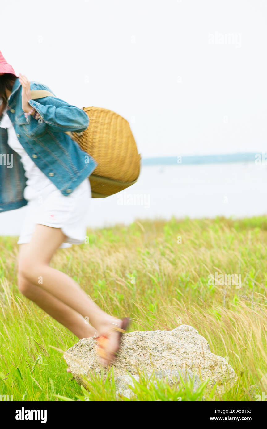 Woman running through grass Stock Photo - Alamy