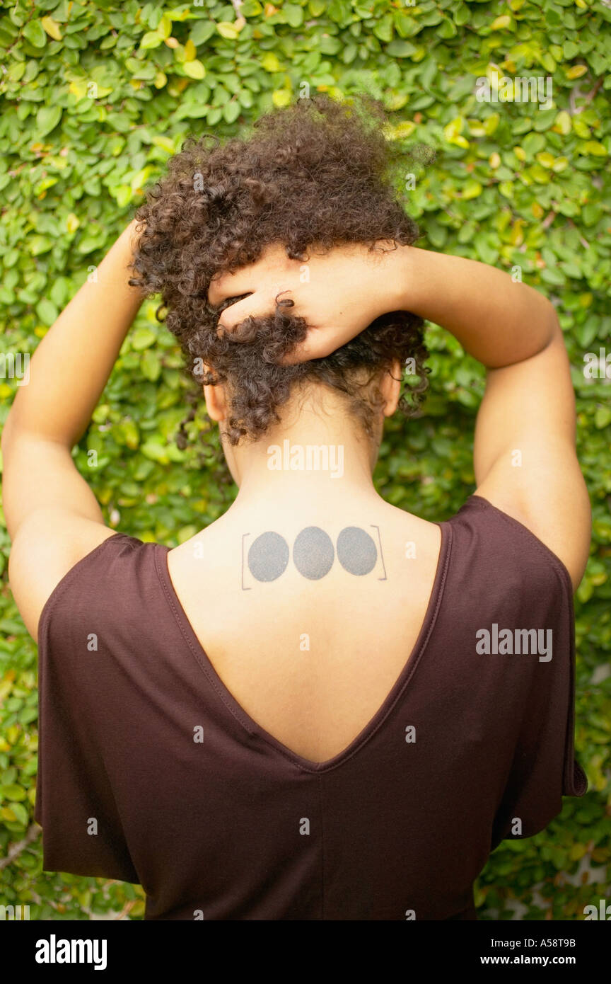 Rear view of woman with tattoos Stock Photo - Alamy