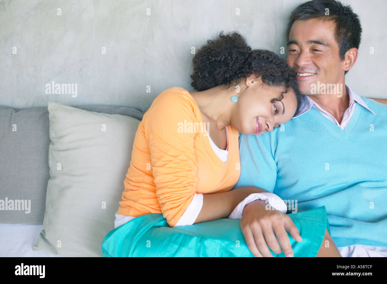 Couple sitting together Stock Photo - Alamy