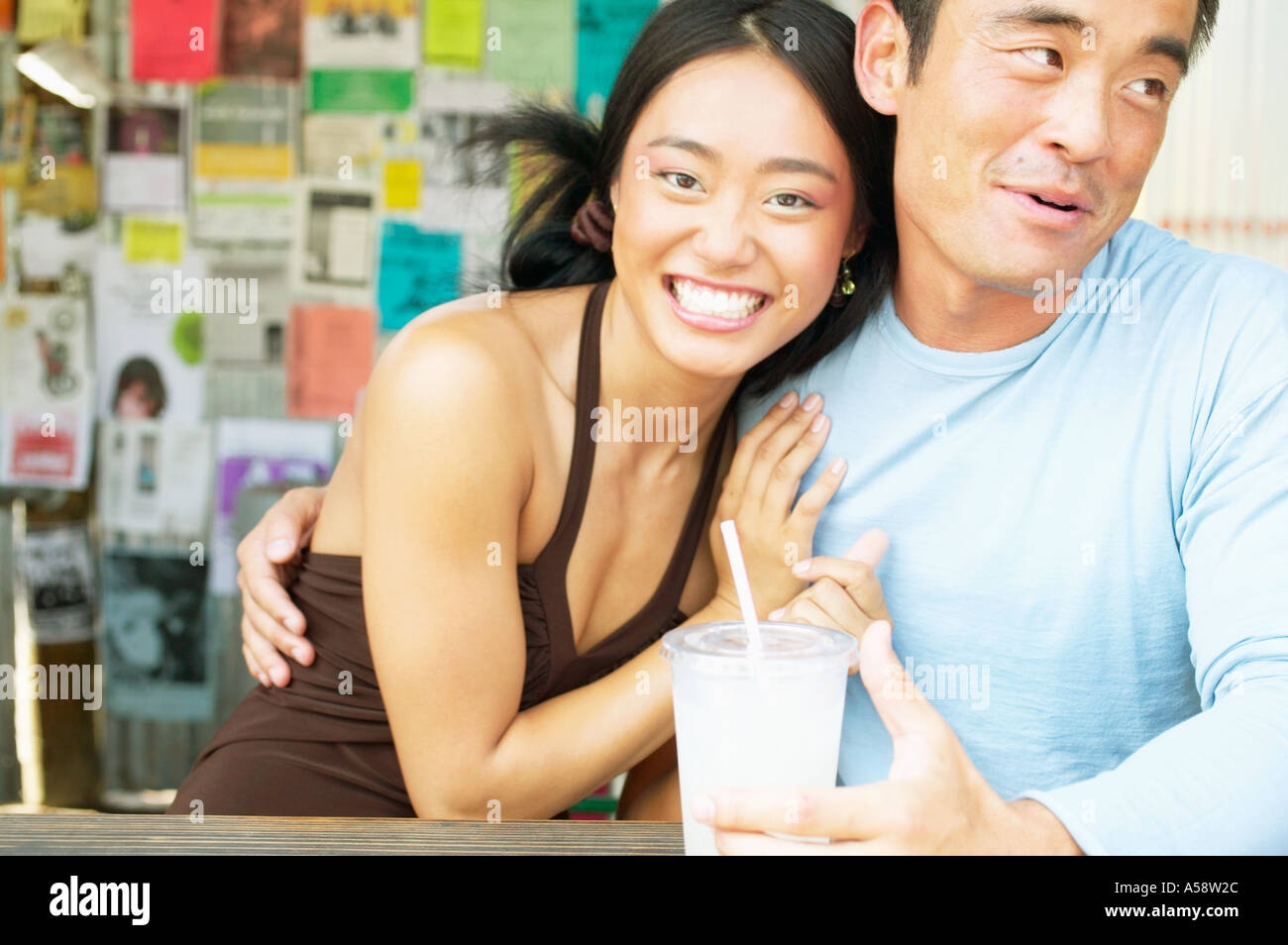 Portrait of couple hugging Stock Photo - Alamy
