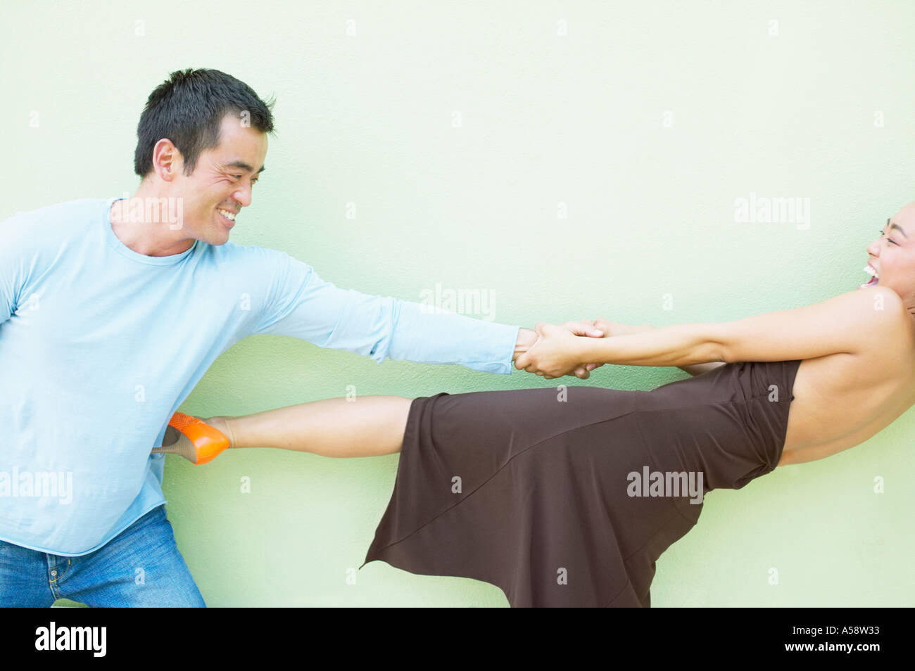 Woman pulling on man s arm Stock Photo - Alamy