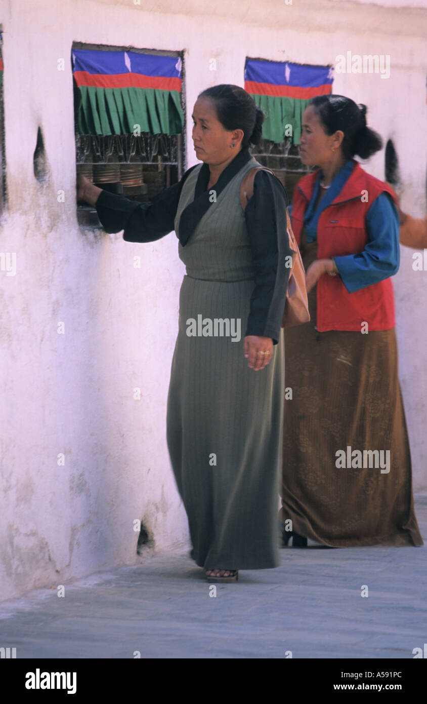 Two pilgrim woman walking around Buddhist Stupa of Bodhnath Kathmandu ...