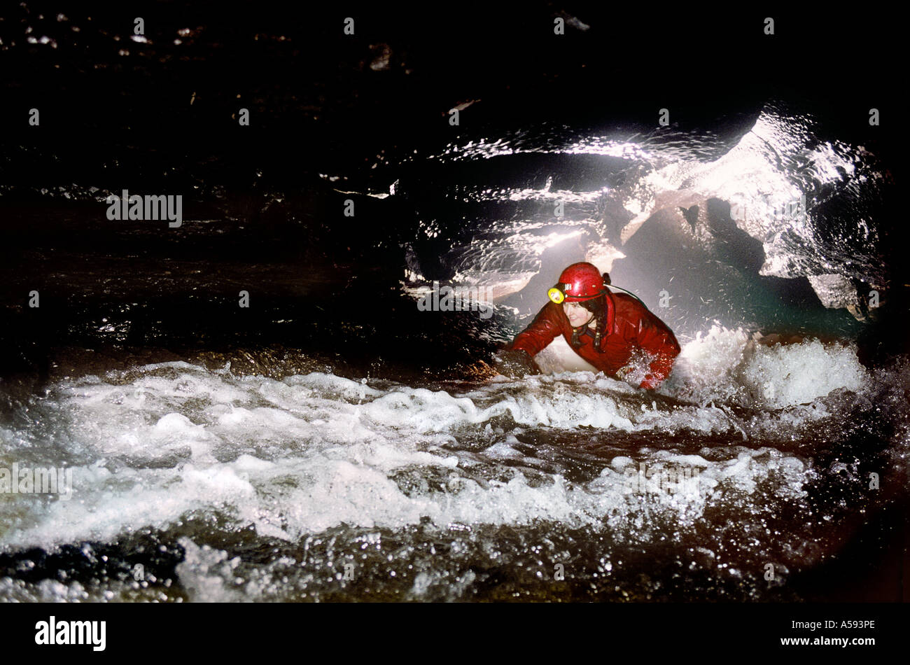 Female caver crawling in South Wales cave streamway UK Stock Photo - Alamy