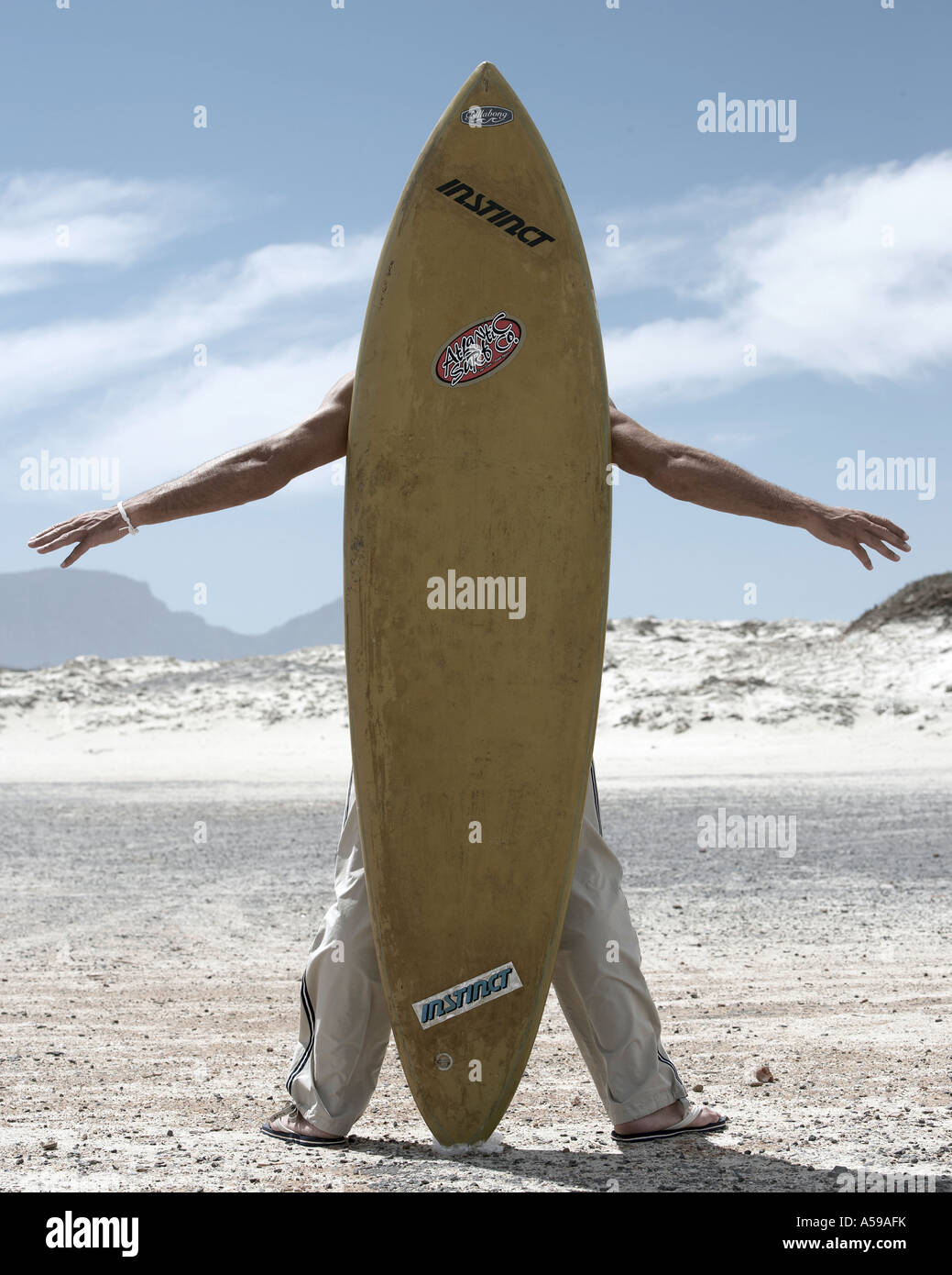 Surfer with surfboard on a beach Stock Photo - Alamy