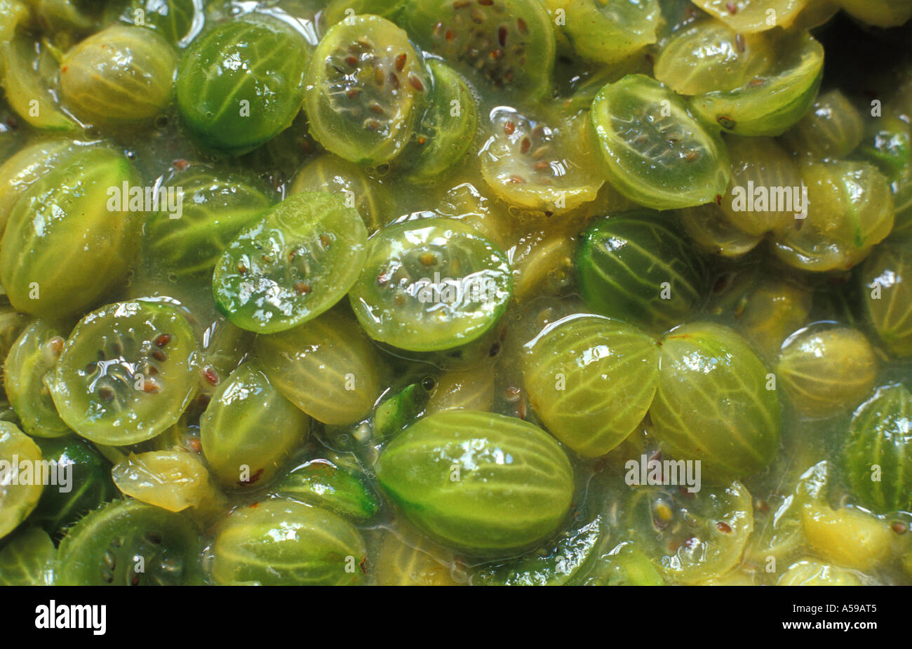 Gooseberries being cooked to make jam or compote They have been halved ...