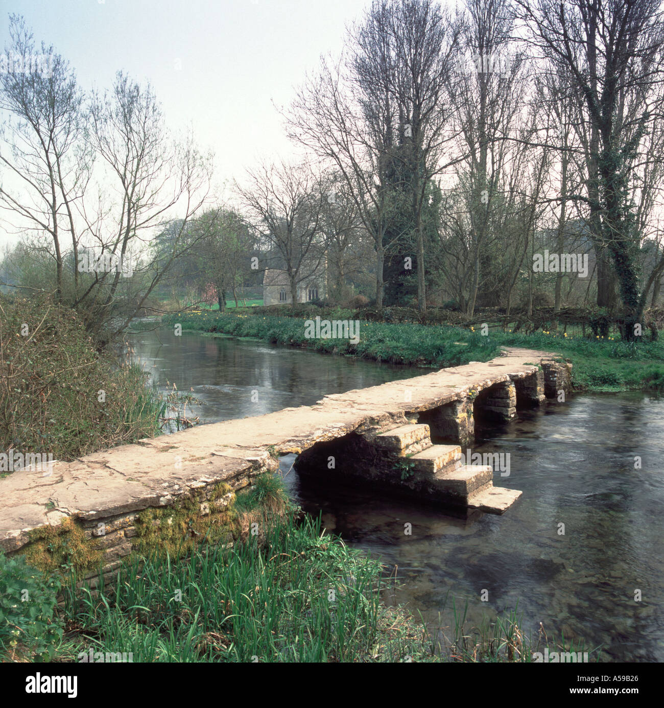 The ancient clapper bridge across the River Leach at Eastleach ...