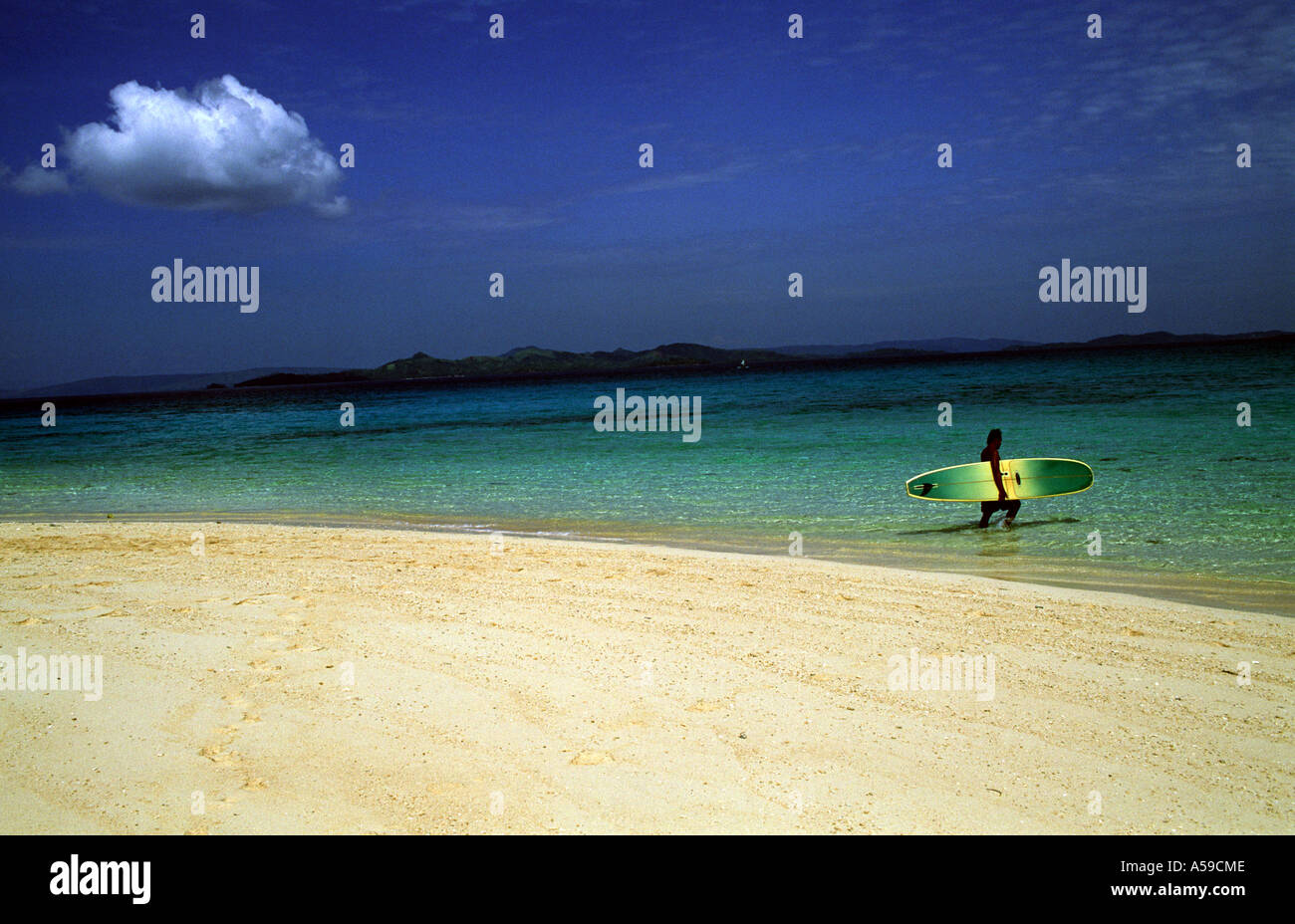 surfer on beach with surfboard philippines Stock Photo - Alamy