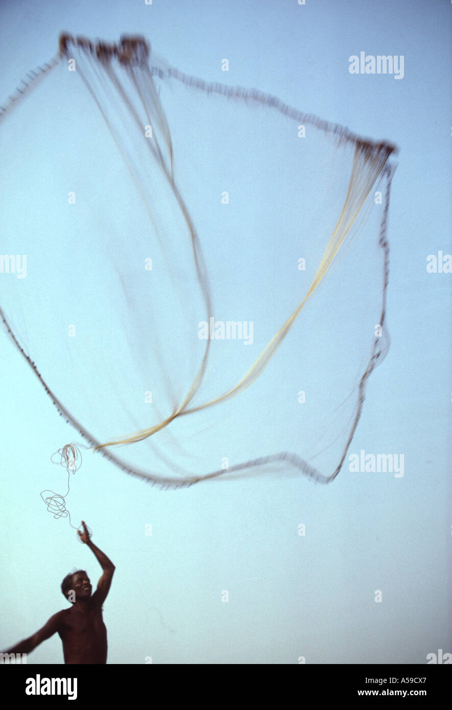 man throwing fishing net india Stock Photo - Alamy