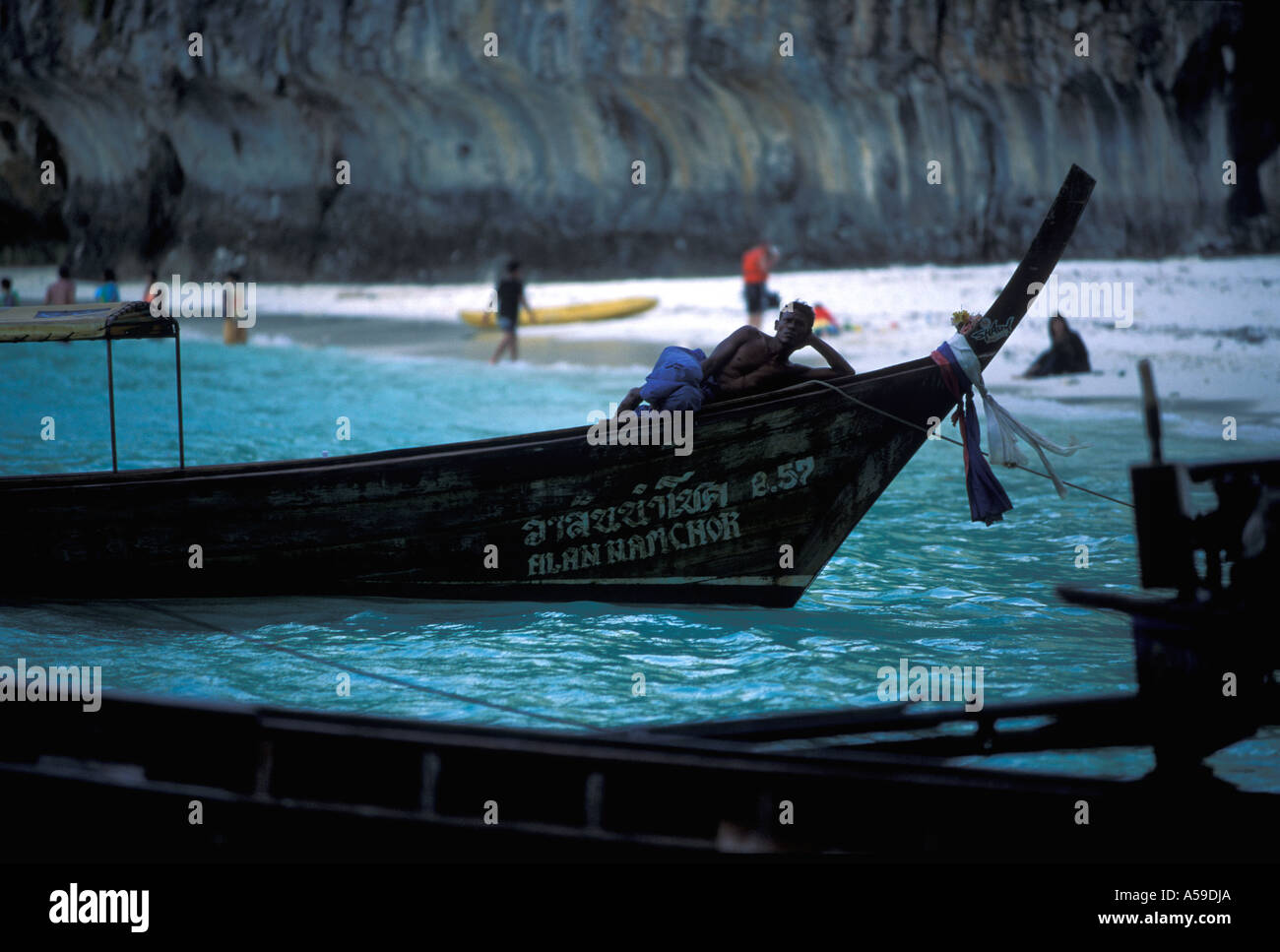 Thai man resting on boat Stock Photo - Alamy
