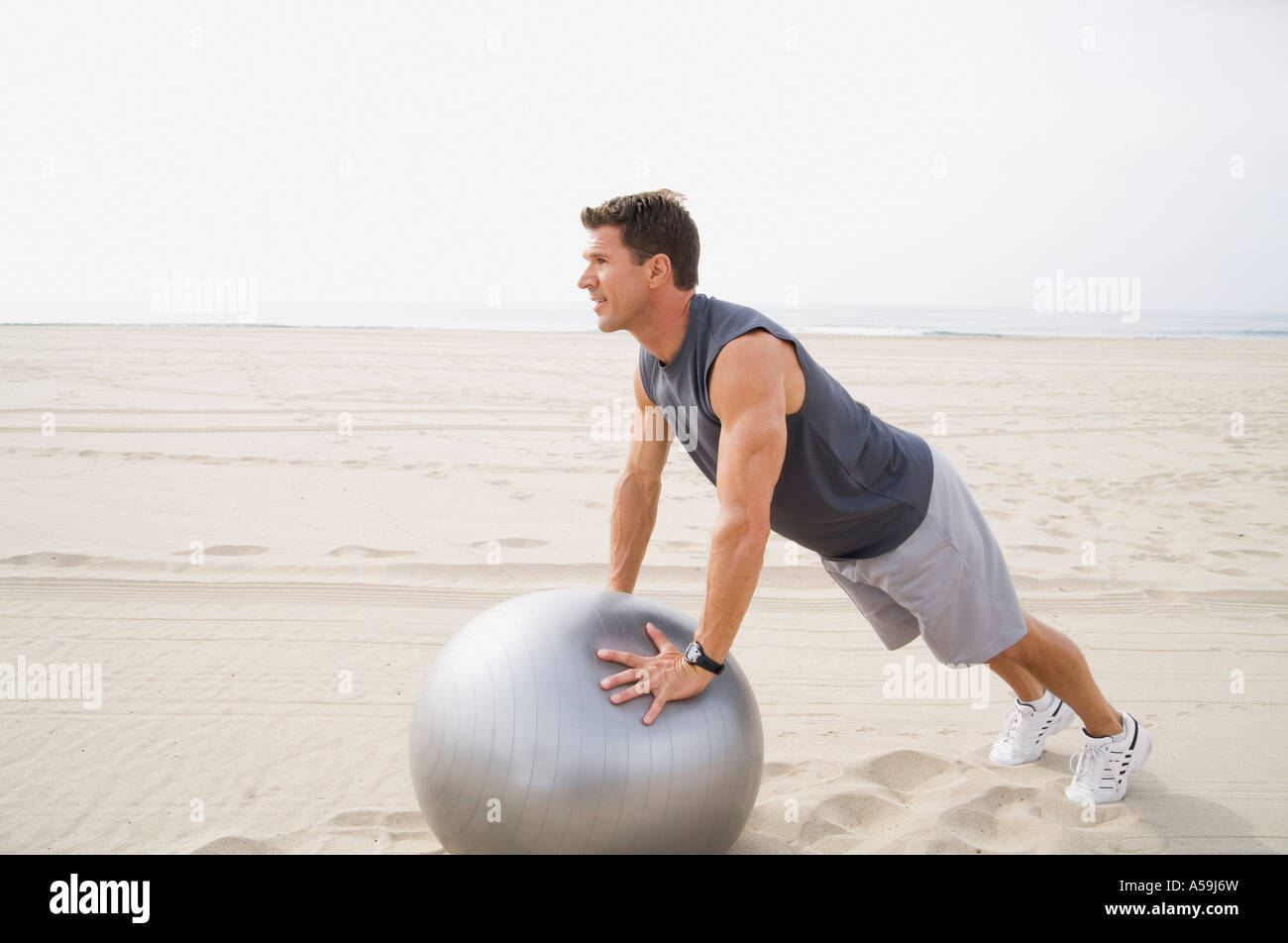 Man Doing Push-Ups at Beach Stock Photo - Alamy