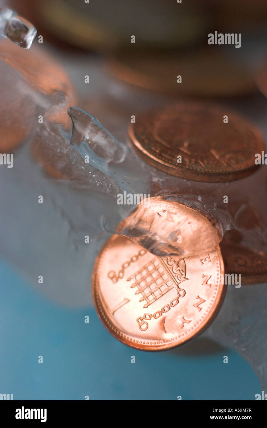 Coins frozen in ice Stock Photo - Alamy