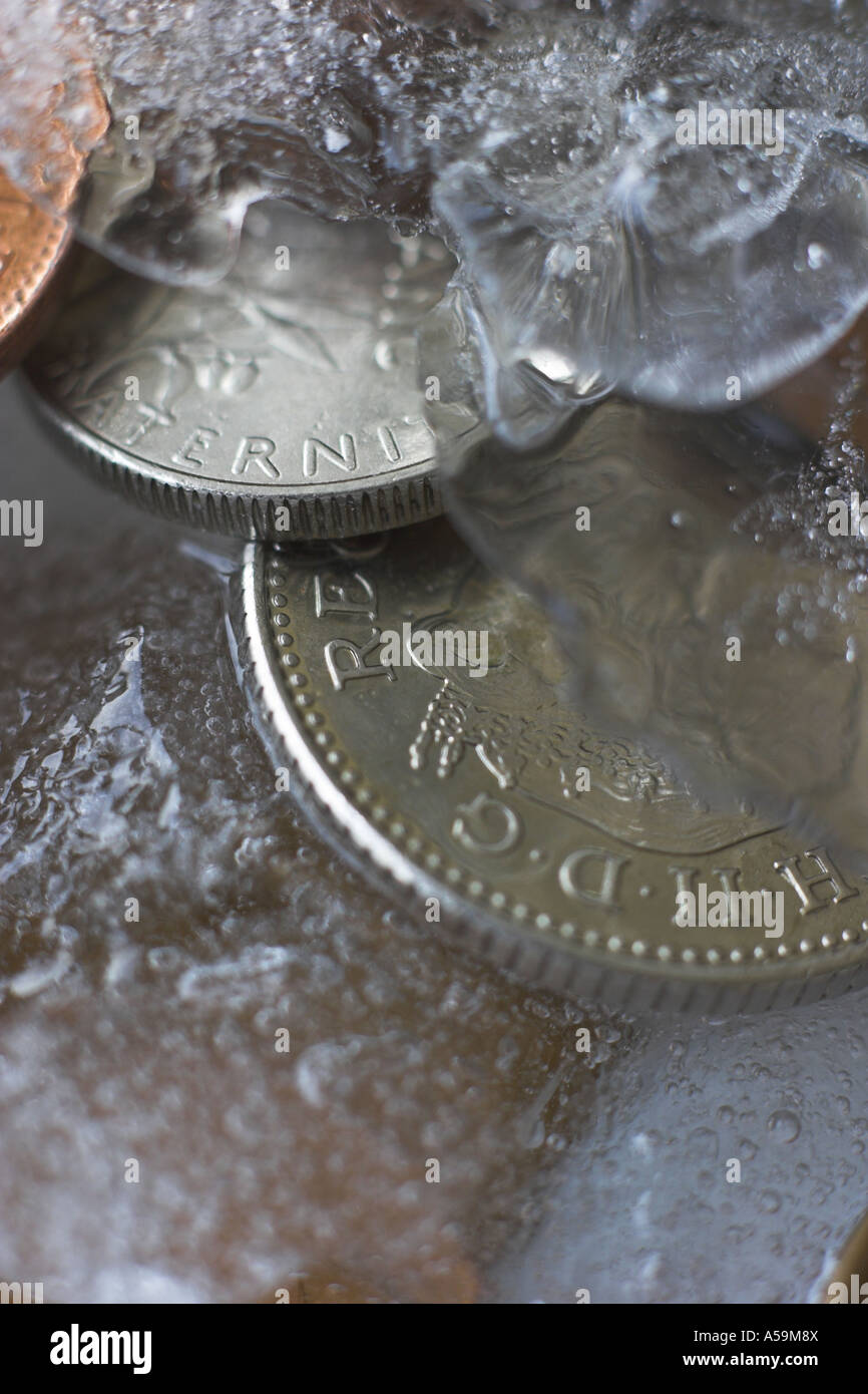 Coins frozen in ice Stock Photo - Alamy