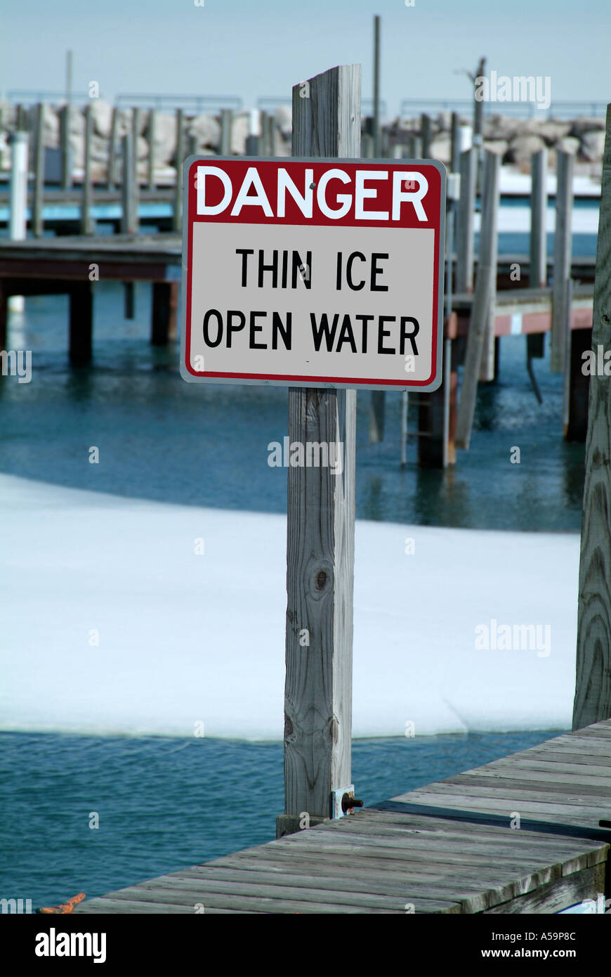 Sign indicating danger thin ice and open water Stock Photo - Alamy