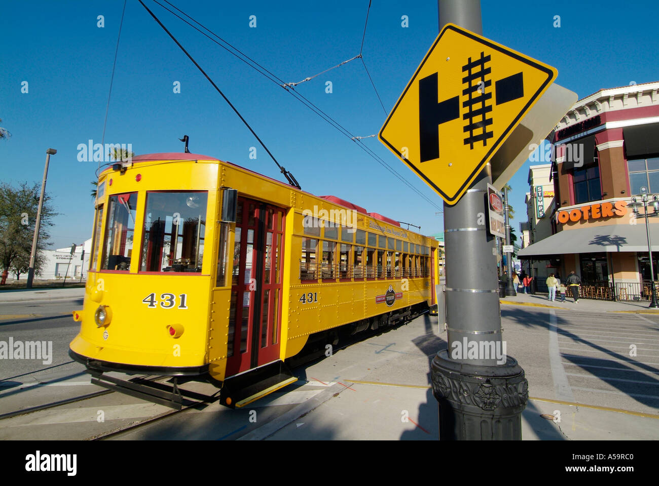 Sign showing a cross street and railroad tracks for railroad train ...
