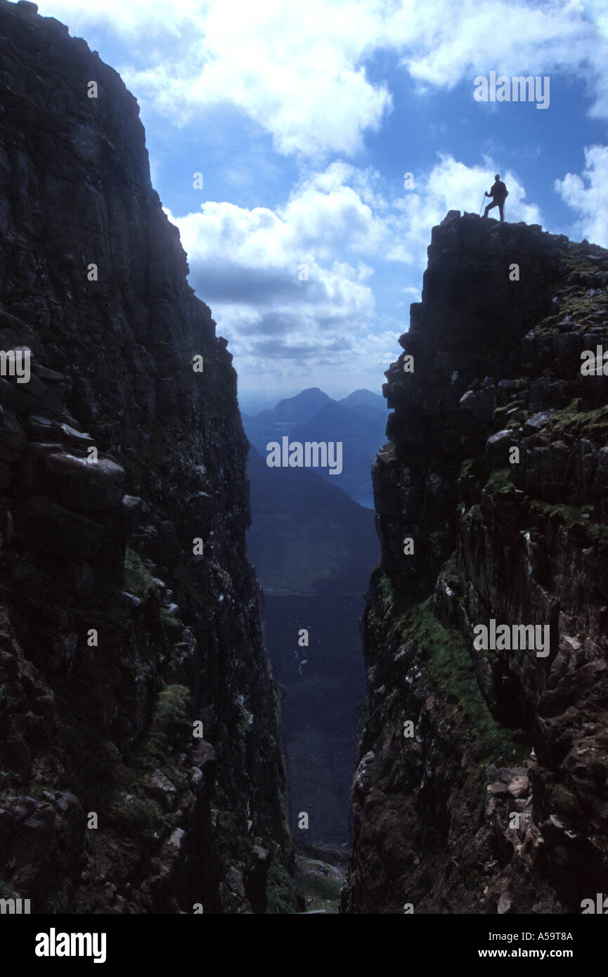 Scotland A climber stands on the edge of a corrie on Ben Eighe in the ...