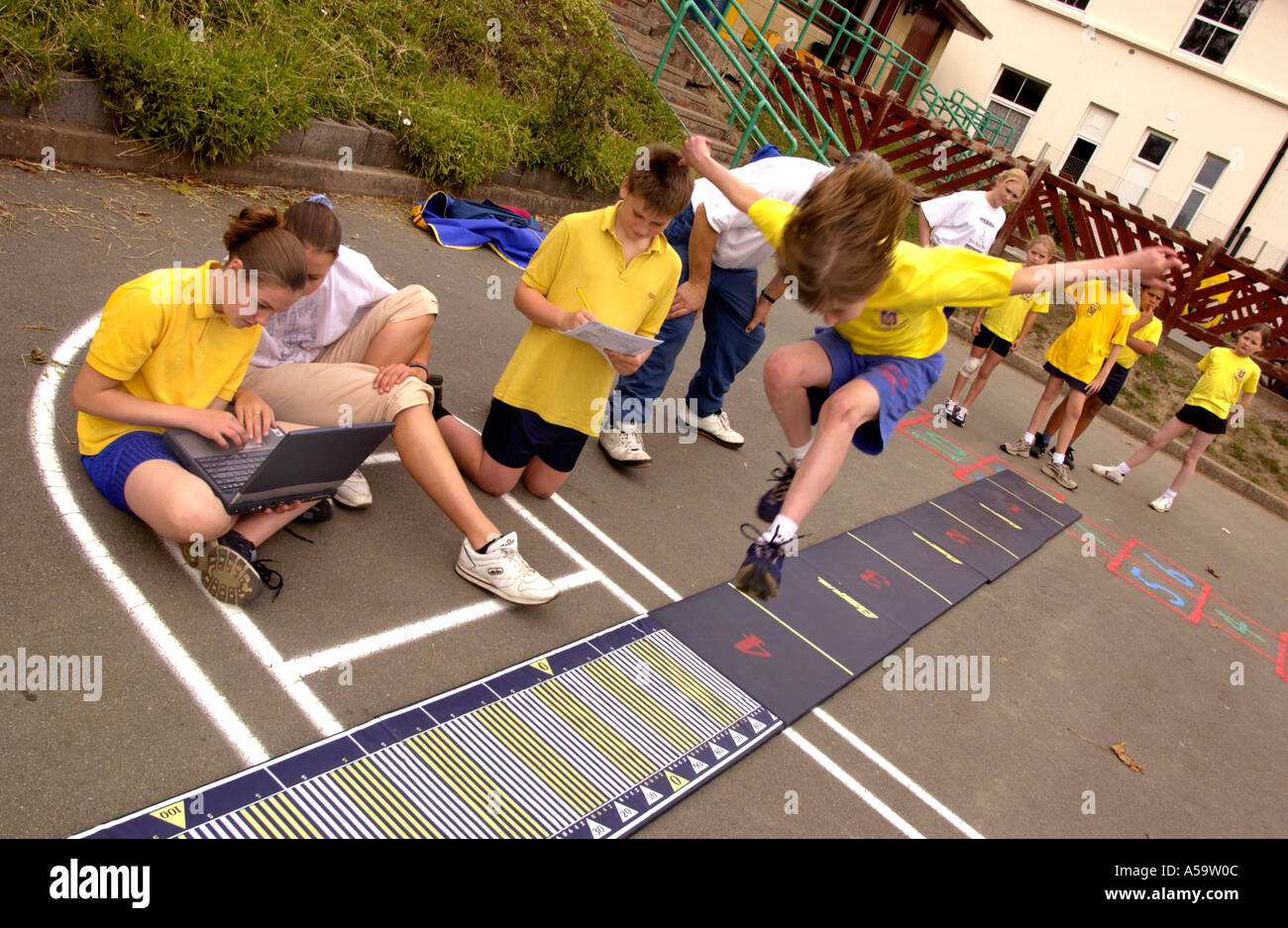 Primary pupils doing a physical sports task and log the results into ...