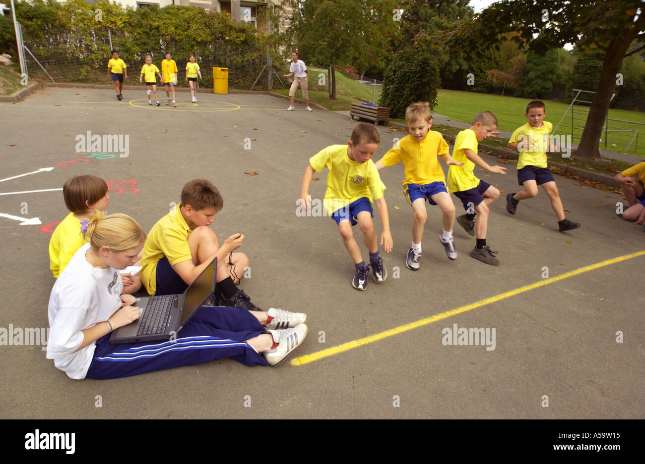 Primary pupils doing a physical sports task and log the results into ...