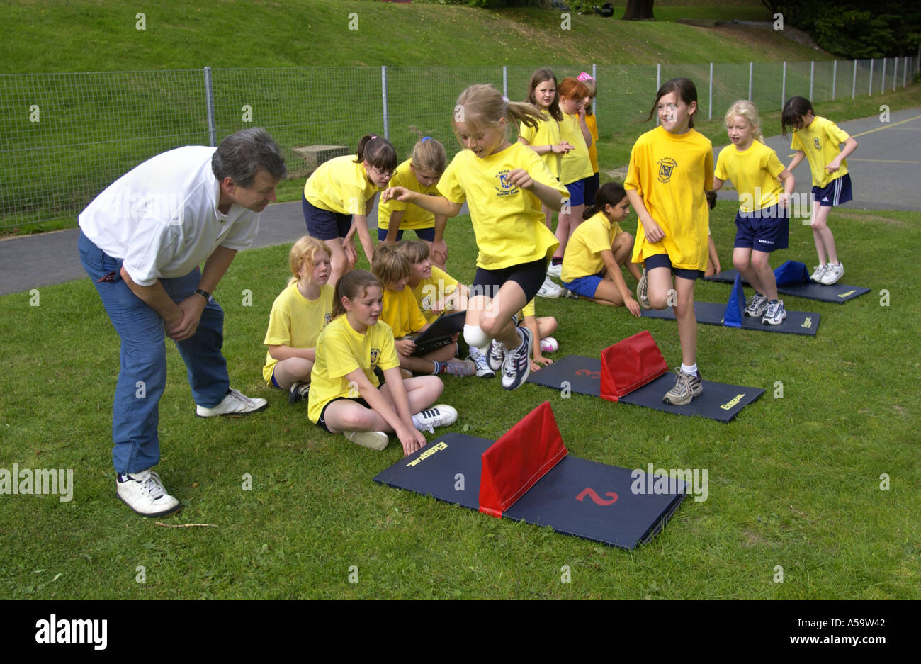 Primary pupils doing a physical sports task and log the results into ...