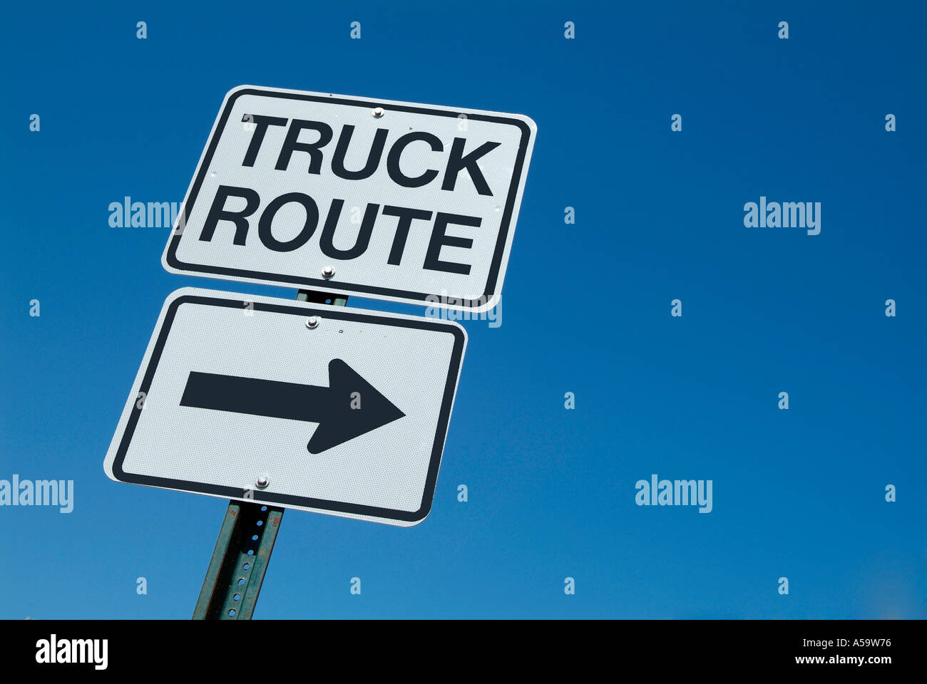 Truck route sign with a turn direction arrow shows routes for large ...