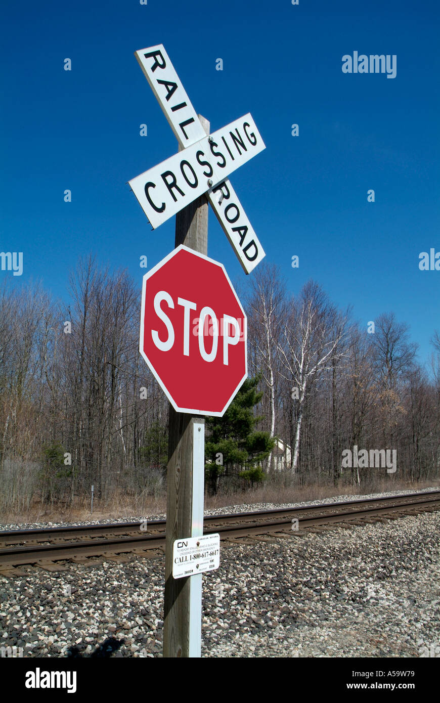 Railroad crossing sign with stop sign at a railroad crossing point ...
