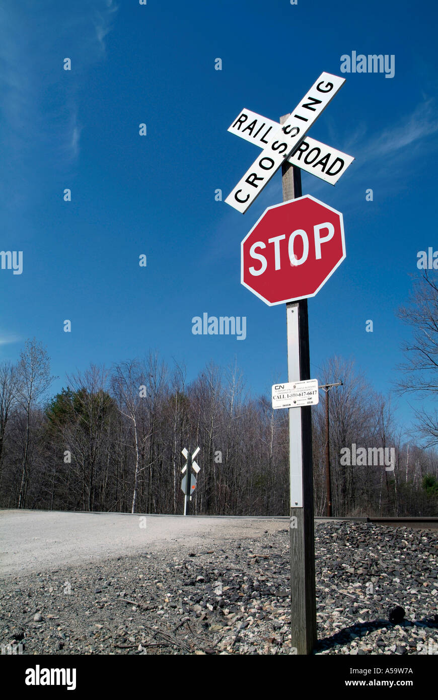 Railroad crossing sign with stop sign at a railroad crossing point ...