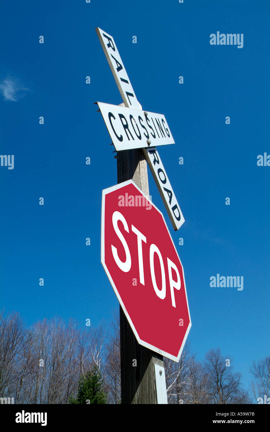 Railroad crossing sign with stop sign at a railroad crossing point ...